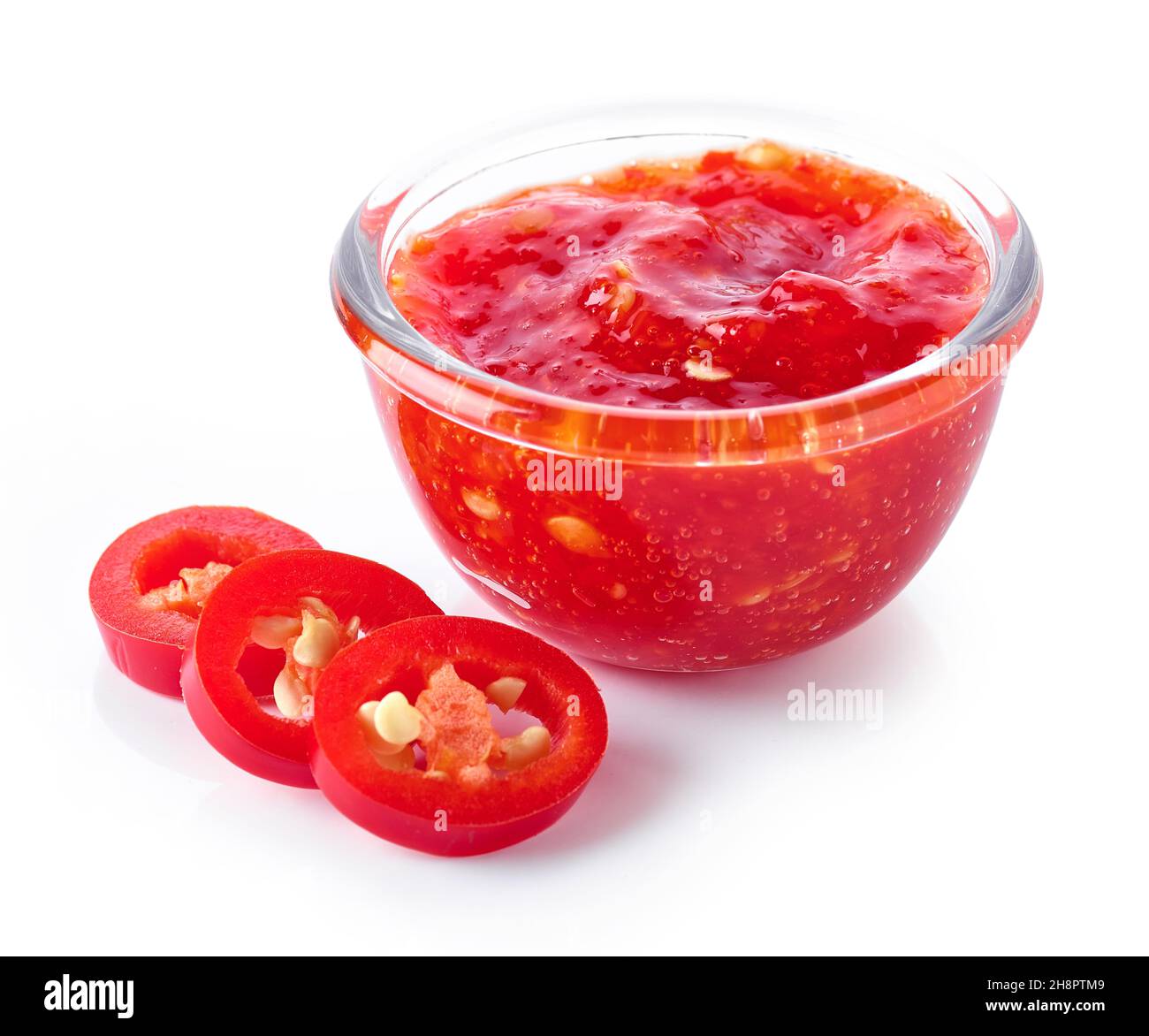 red hot chili pepper sauce and sliced chili isolated on white ...
