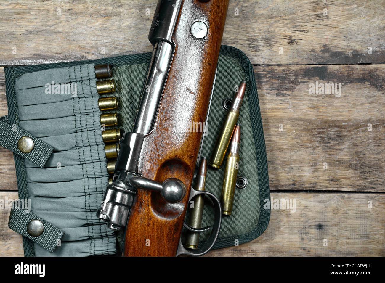 Old Hunting rifle and ammunition on a wooden background.Top view Stock ...