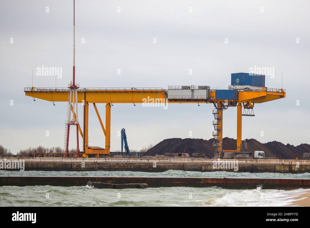 coal terminal of seaport. Heaps of coal in port awaiting loading on ...