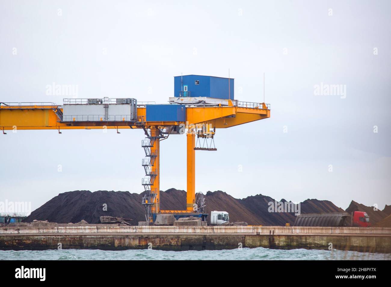 coal terminal of seaport. Heaps of coal in port awaiting loading on ...