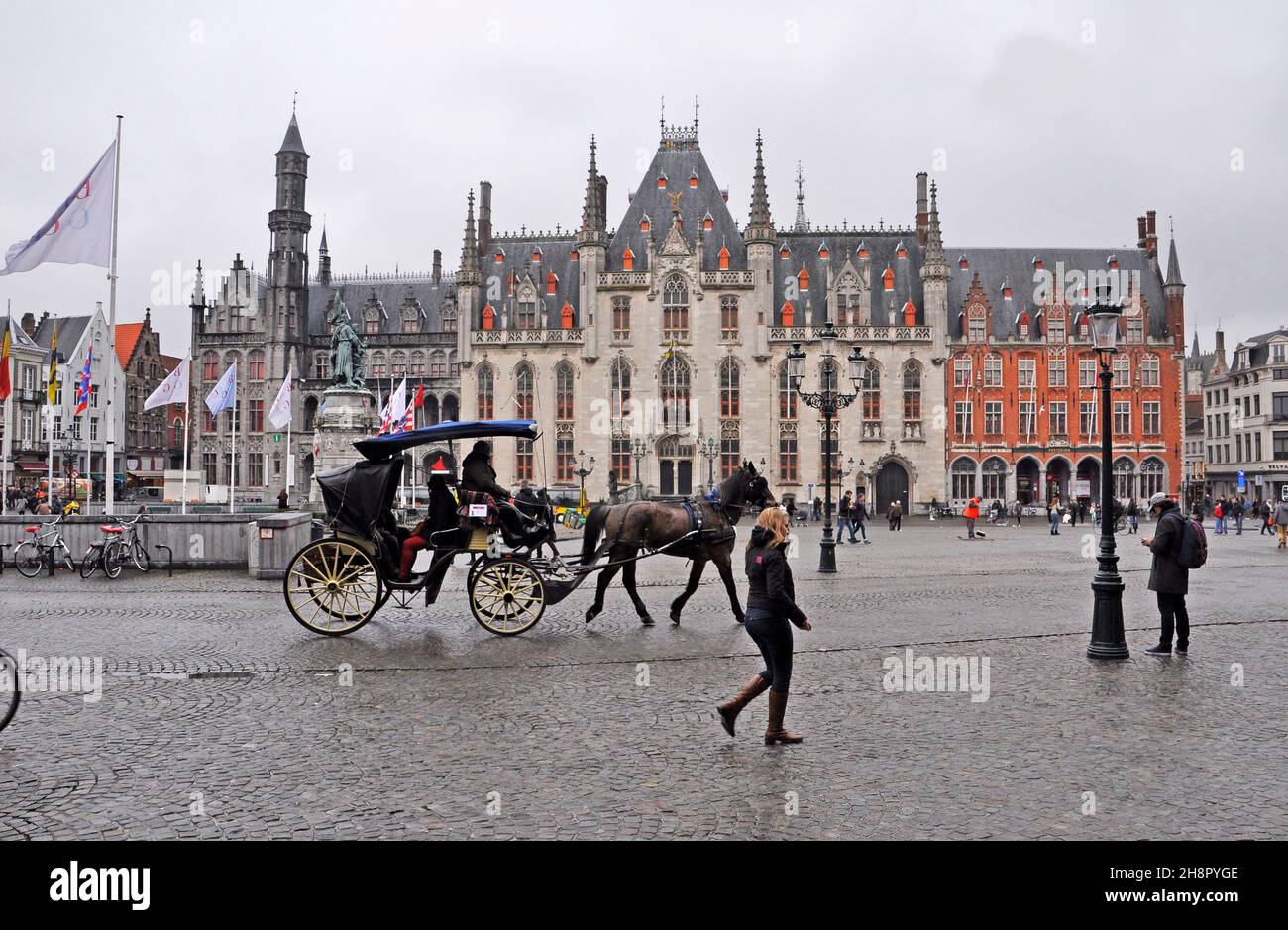 The historic centre of Bruges in Belgium with a Horse- drawn carriage ...