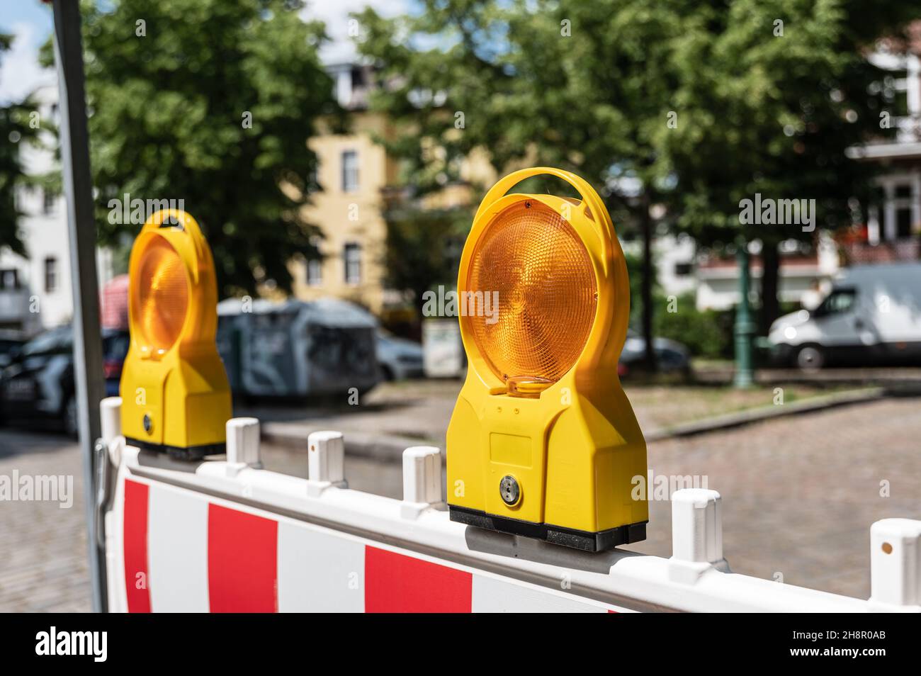 two Orange hazard lights on a construction site barrier Stock Photo - Alamy