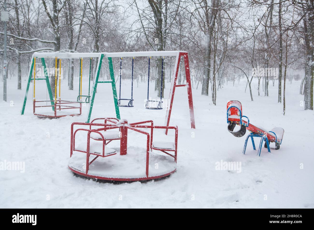 white snow and playground. playground in the snow in winter during a ...