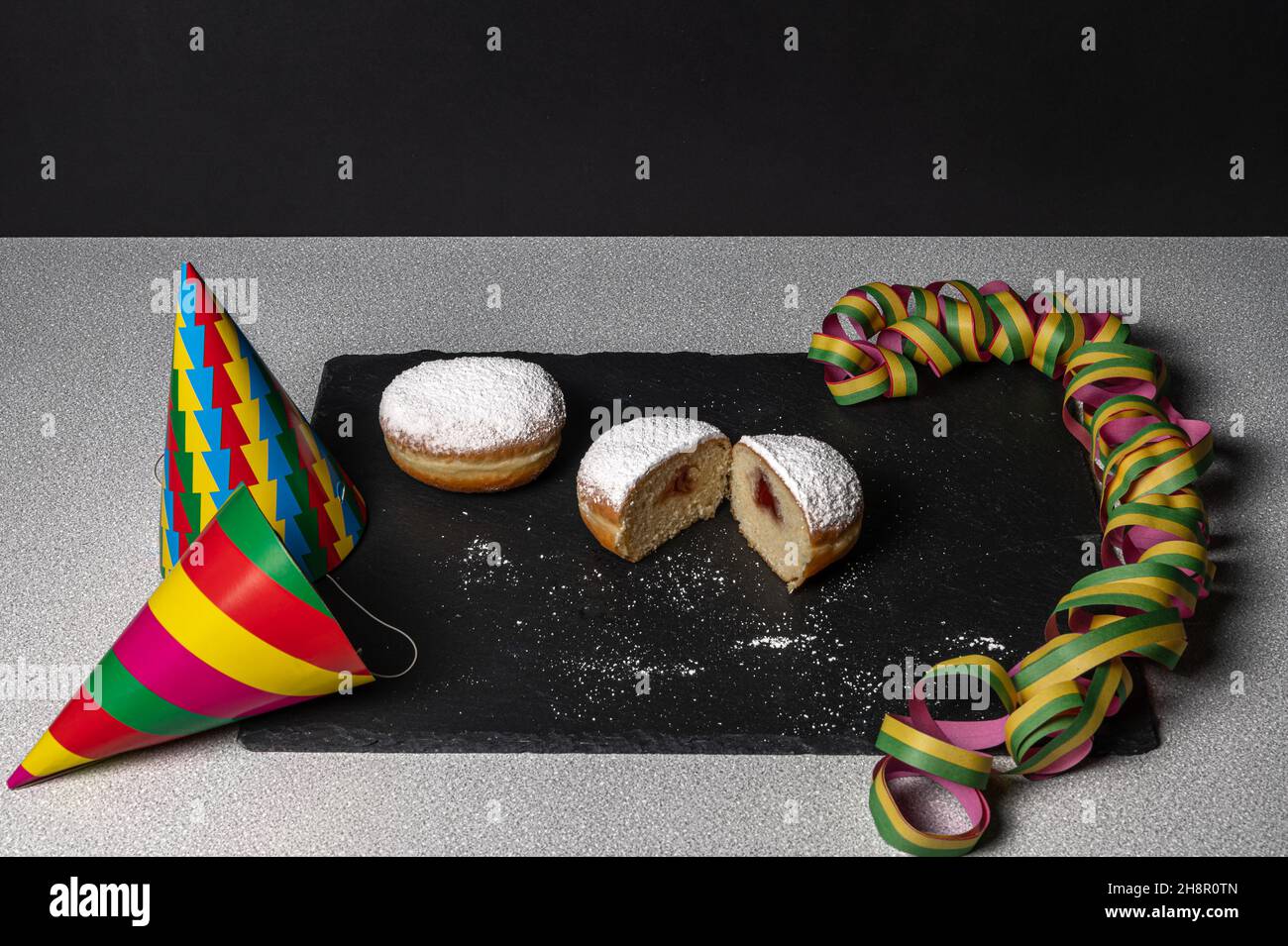 two Berlin carnival donuts with a festive decoration Stock Photo - Alamy