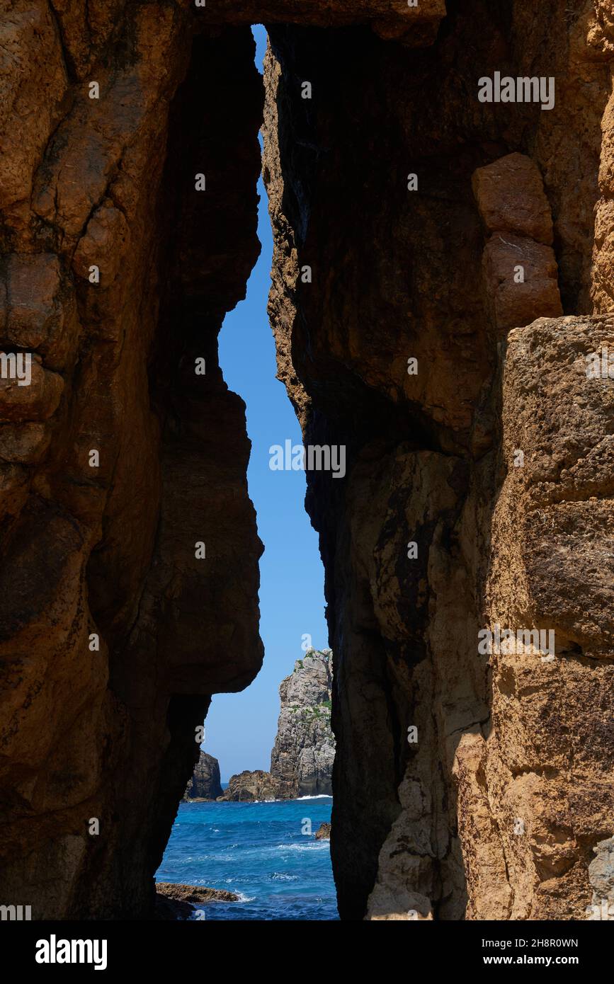 A large gap in some cliffs where you can see the sea on the other side ...
