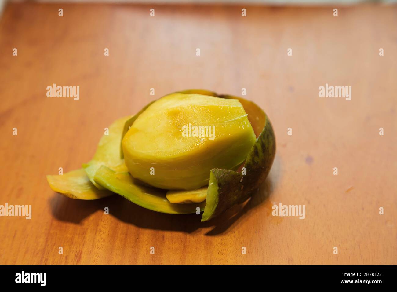 Peeled exotic golden apple fruit Stock Photo - Alamy