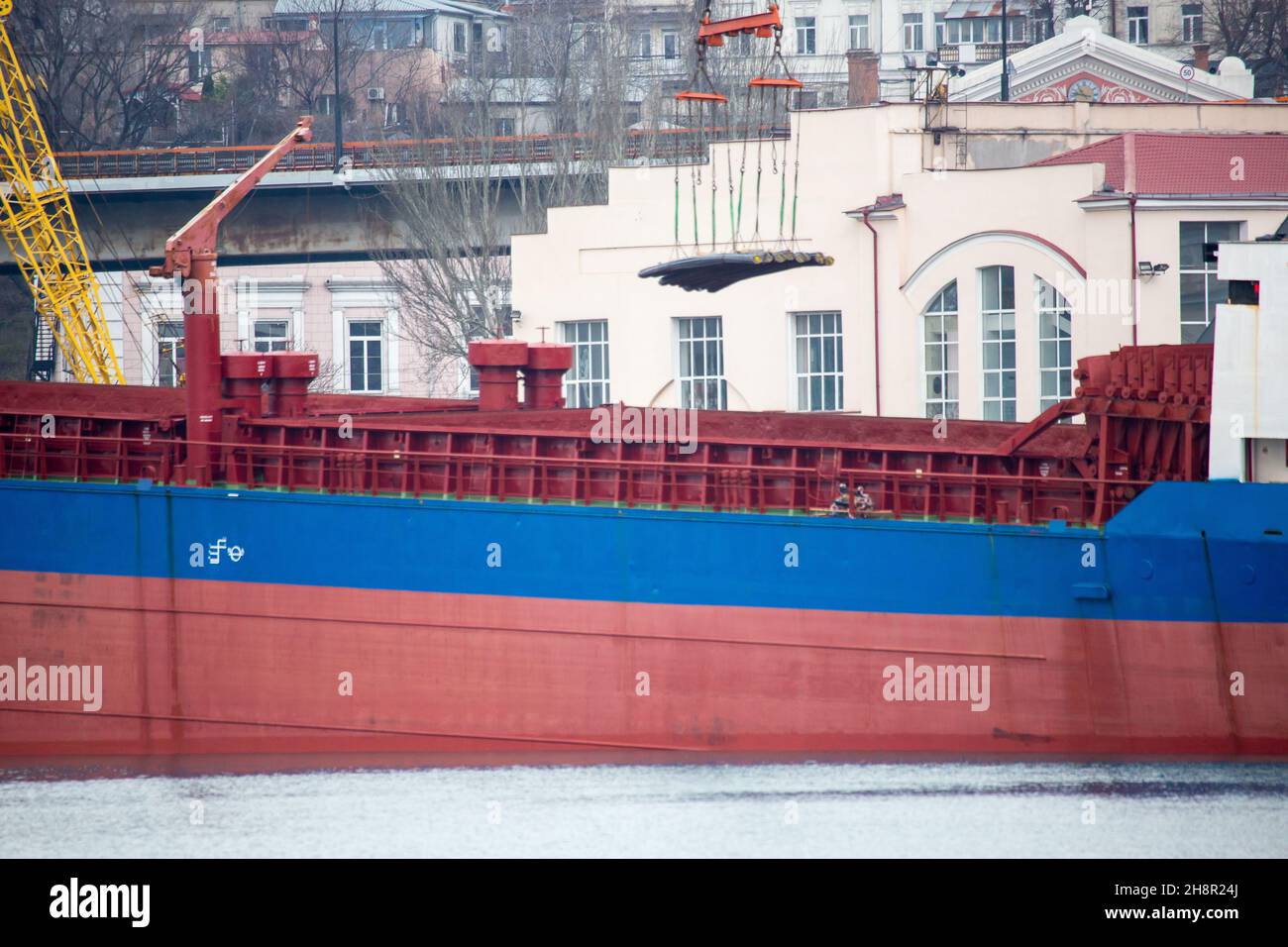 Vessel dry cargo on loading, unloading in port. Bulker in port. port crane loads bulk cargo at ...