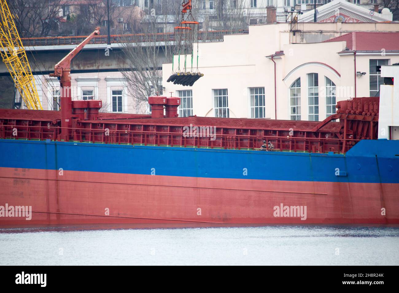 Vessel dry cargo on loading, unloading in port. Bulker in port. port crane loads bulk cargo at ...