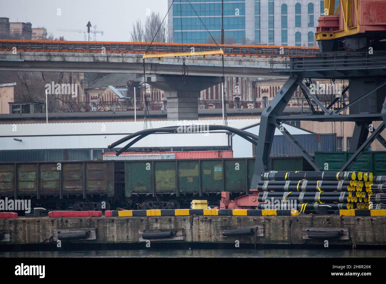 Railroad cars in port for loading unloading. Port cranes unload, load ...