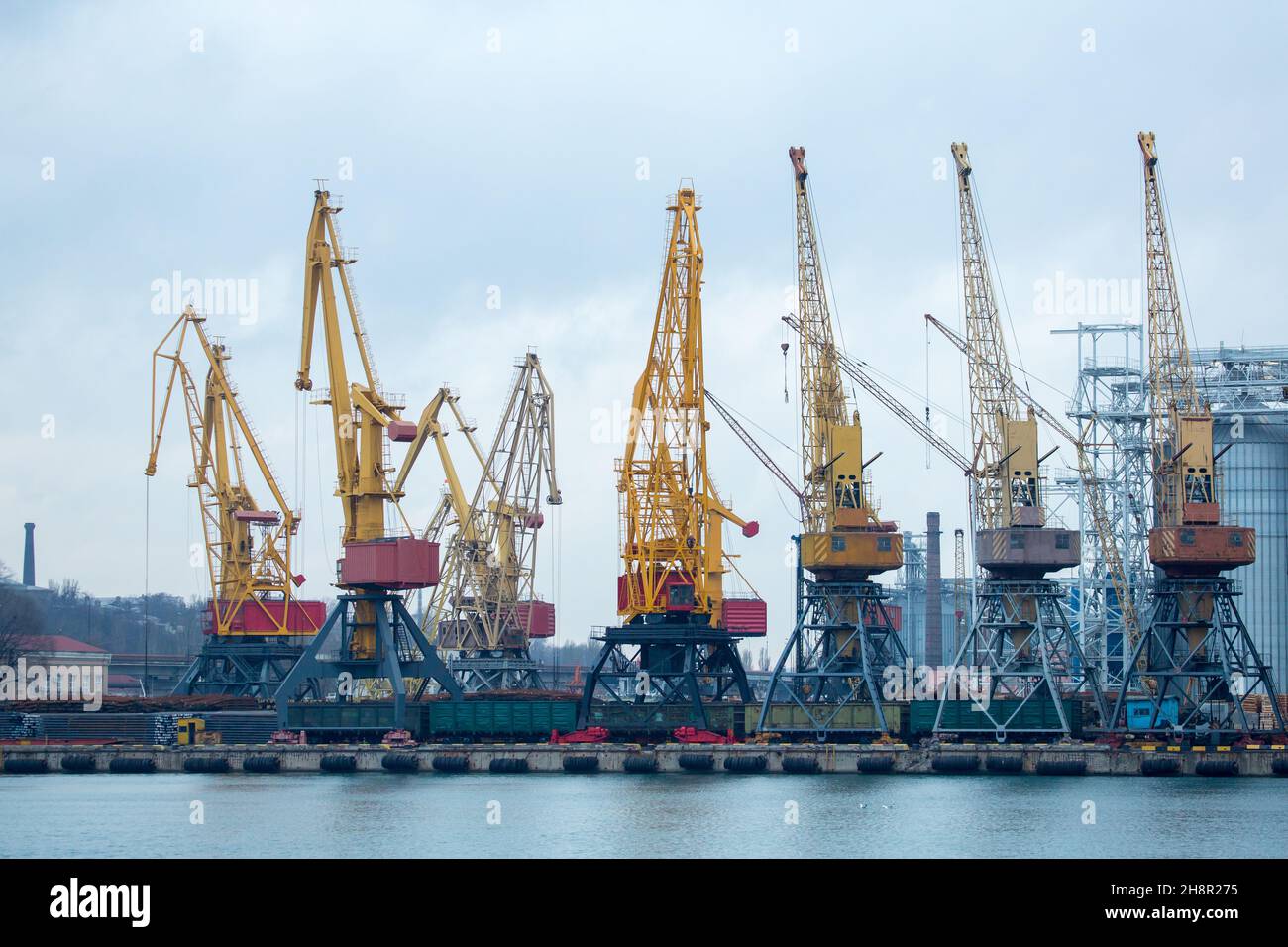Railroad cars in port for loading unloading. Port cranes unload, load ...