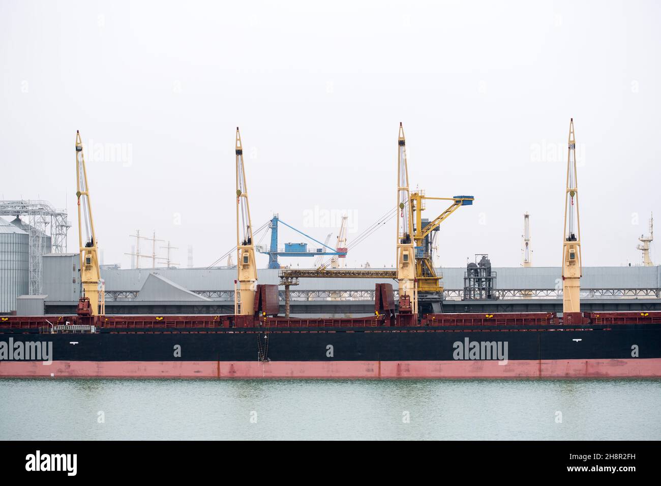Vessel dry cargo on loading, unloading in port. Bulker in port. port ...