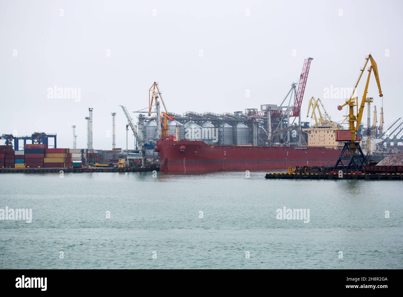 Port terminal of bulk cargo. Port elevator with loading vessel Stock ...