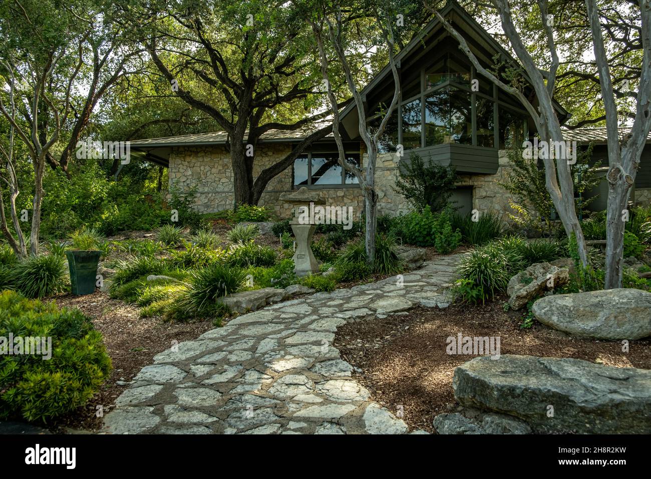 Road leading to a house through a cozy garden Stock Photo - Alamy