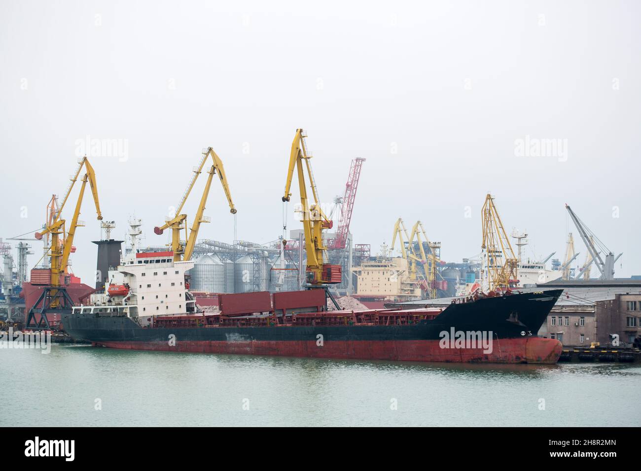 Vessel dry cargo on loading, unloading in port. Bulker in port. port ...