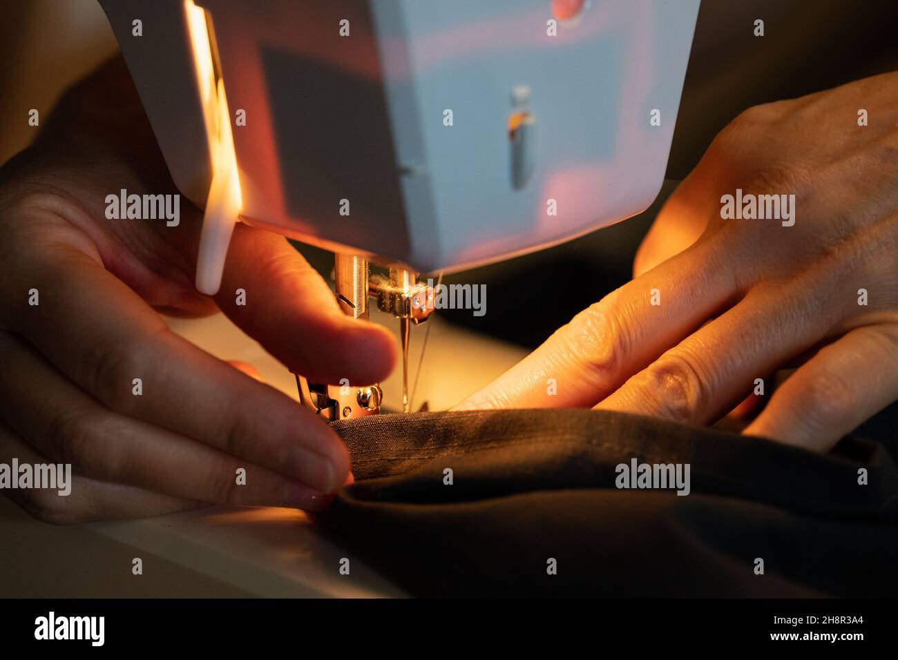 woman's hands sew on a sewing machine, close up, working process Stock ...