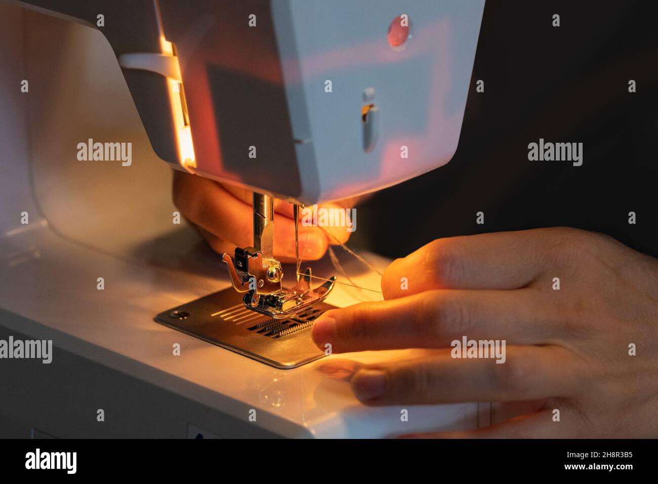 woman's hands sew on a sewing machine, close up, working process Stock ...