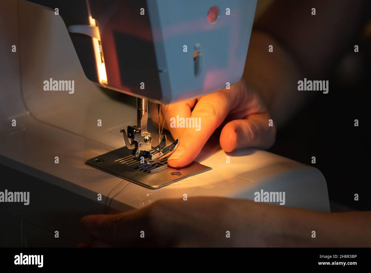 woman's hands sew on a sewing machine, close up, working process Stock ...