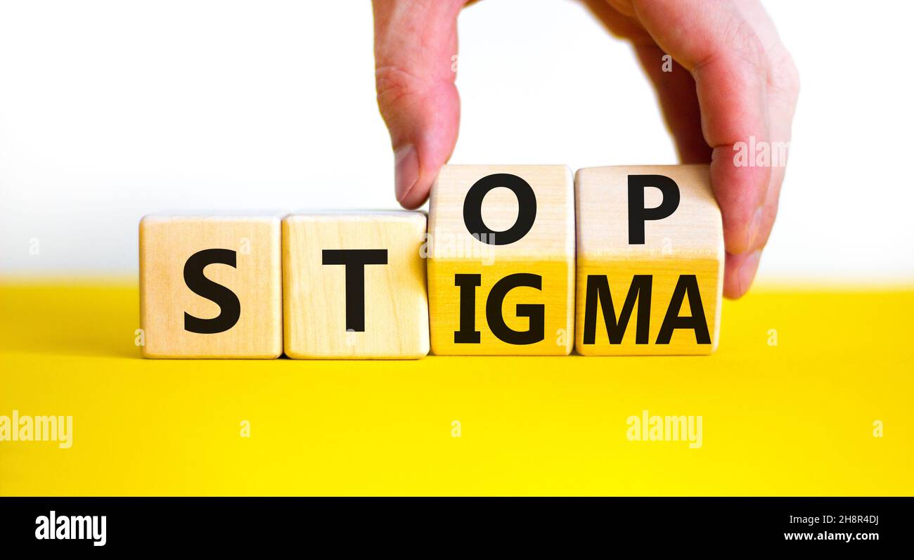 Stop stigma symbol. Doctor turns wooden cubes with words stop stigma ...