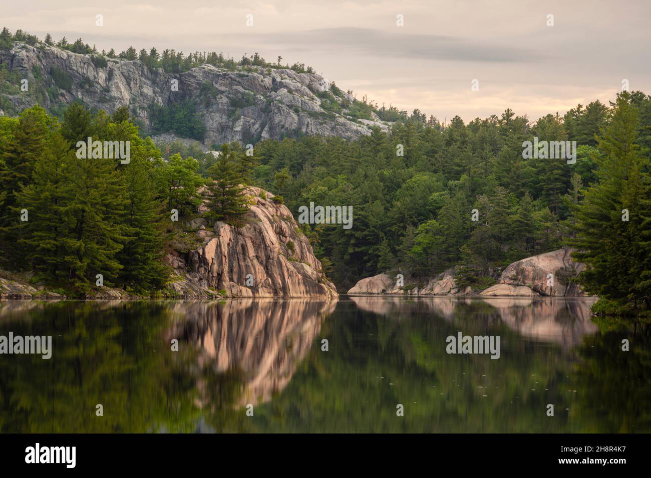 Granite outcrop reflections in George Lake, Killarney Provincial Park ...
