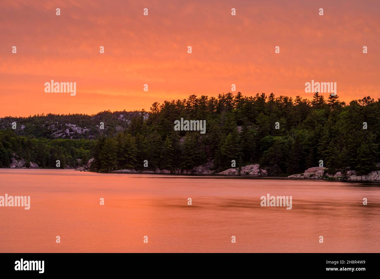 Sunset sky reflections in George Lake, Killarney Provincial Park ...