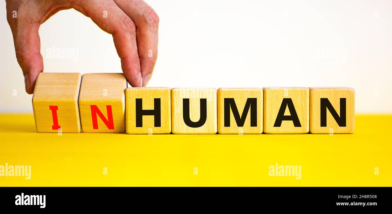 Human or inhuman symbol. Businessman turns wooden cubes and changes the ...