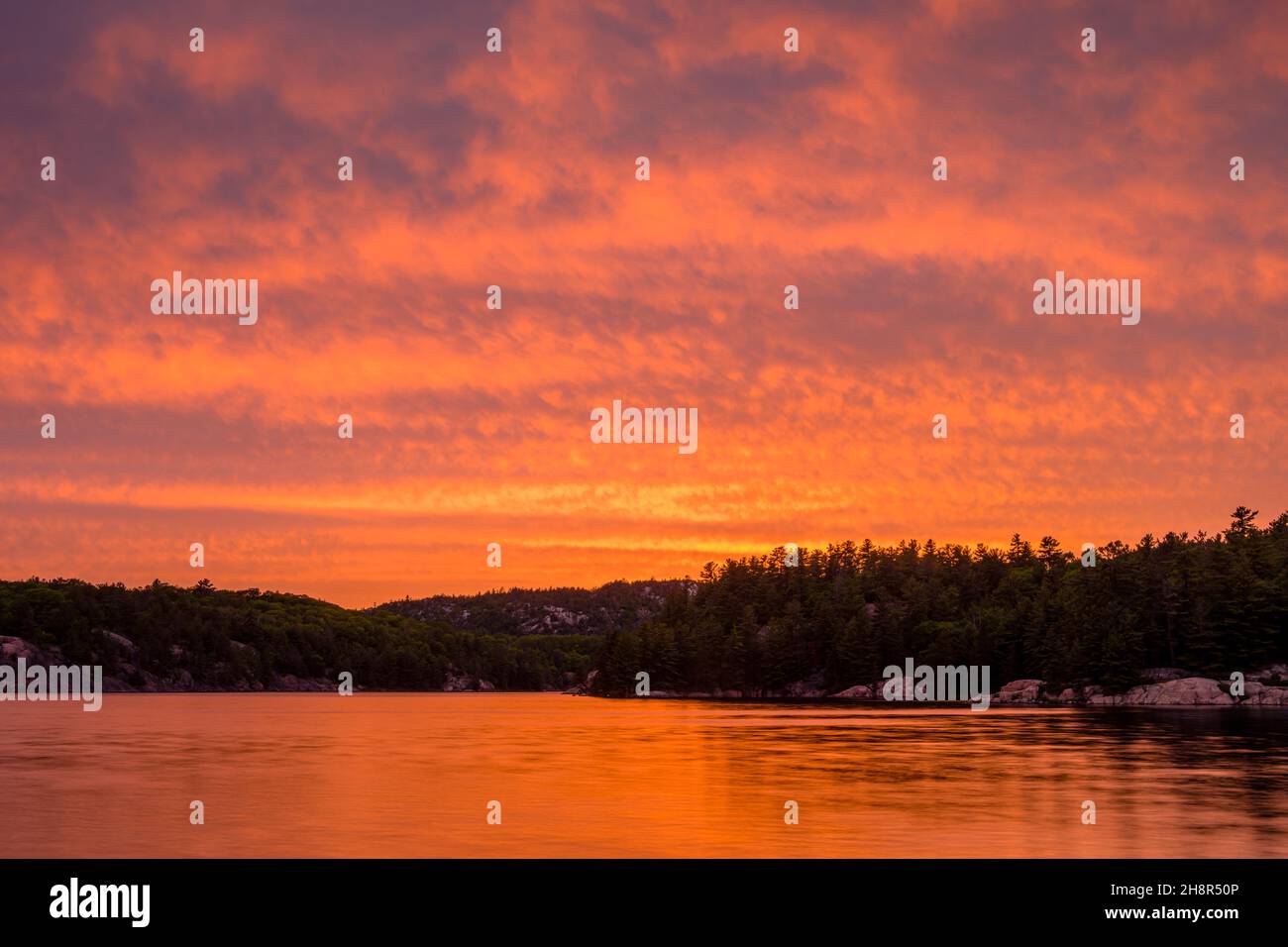 Sunset sky reflections in George Lake, Killarney Provincial Park ...