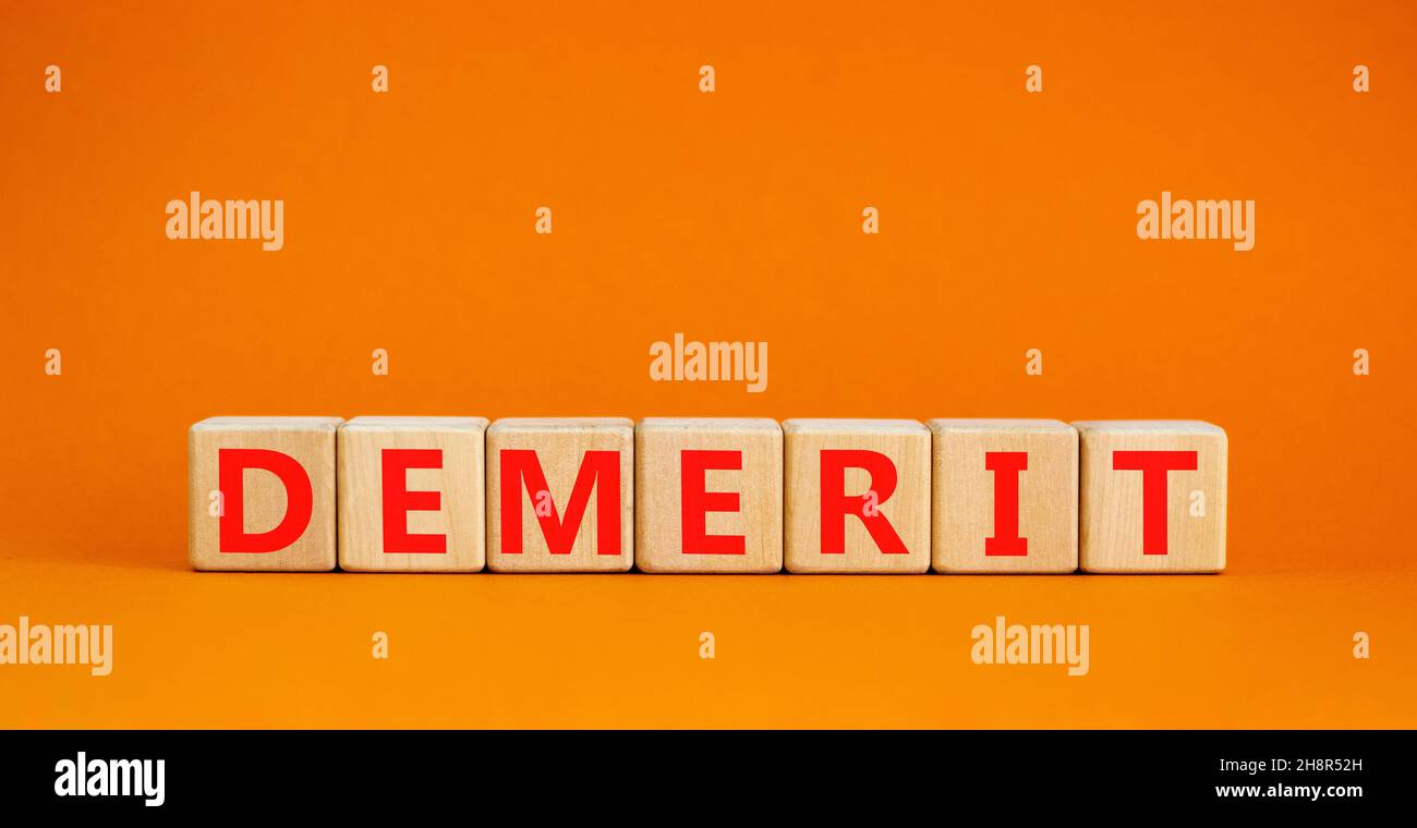 Demerit symbol. The concept word Demerit on wooden cubes. Beautiful ...