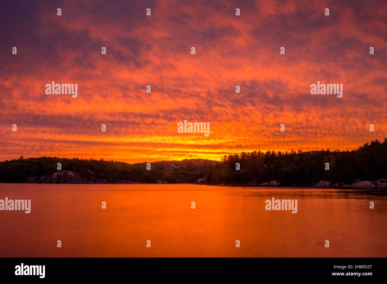 Sunset sky reflections in George Lake, Killarney Provincial Park ...