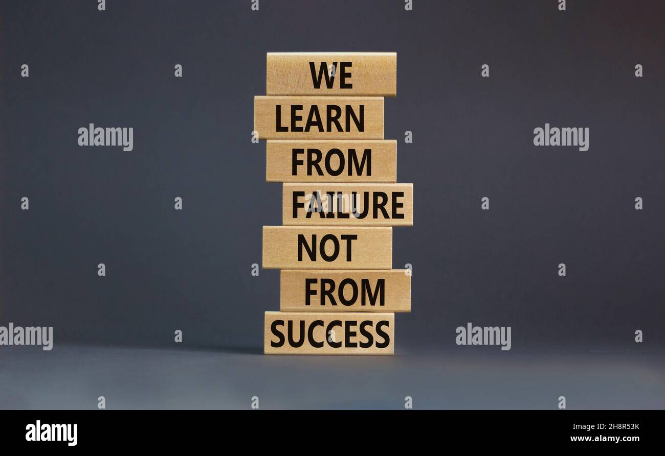 Failure or success symbol. Wooden blocks with words We learn from ...