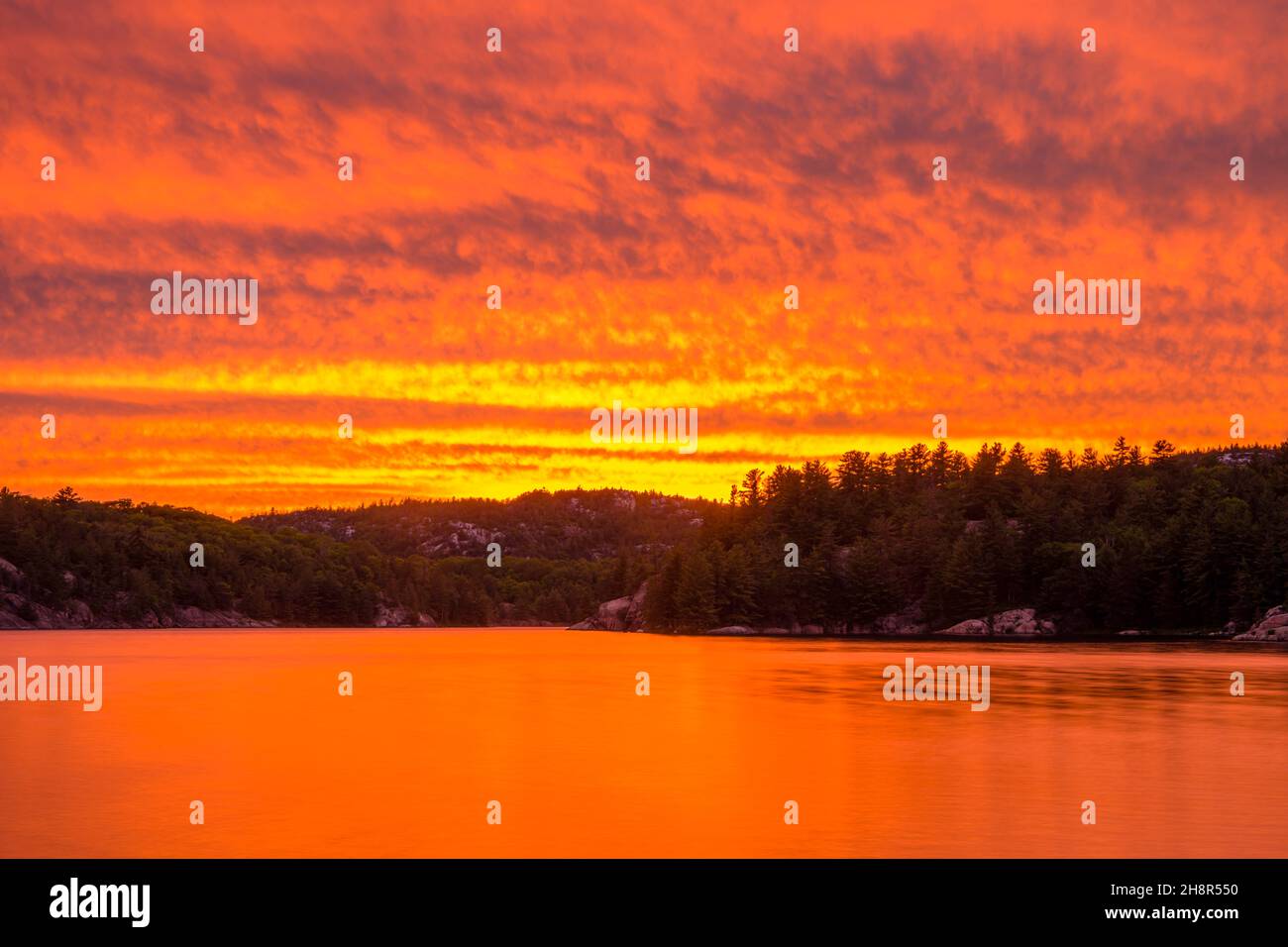 Sunset sky reflections in George Lake, Killarney Provincial Park ...