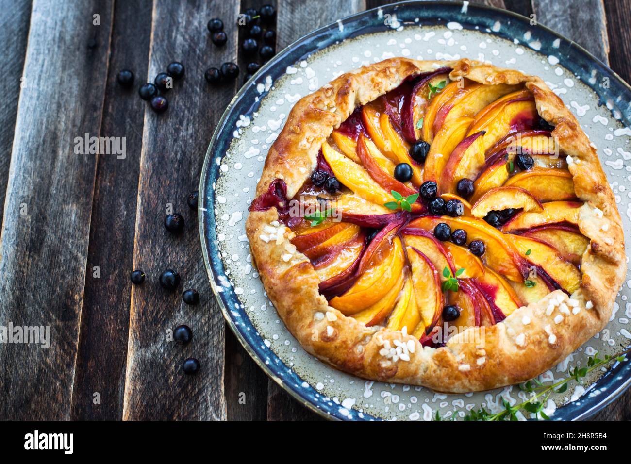 Rustic sweet open pie (galette) with peach and berry Stock Photo - Alamy