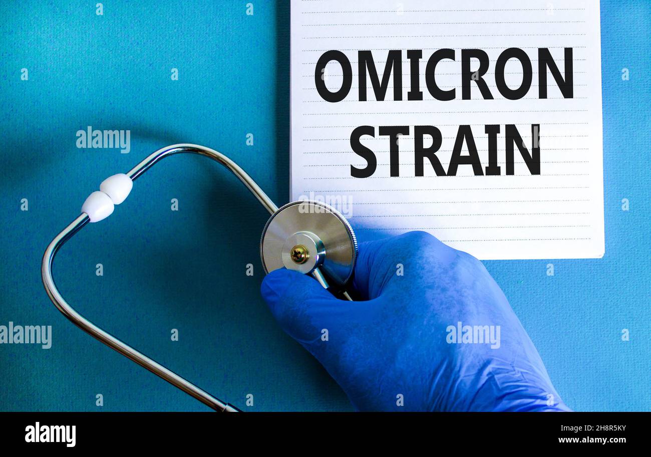 New covid-19 omicron variant strain symbol. Hand in blue glove with ...