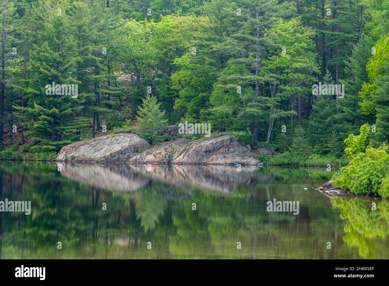 Granite outcrop reflections in George Lake, Killarney Provincial Park ...