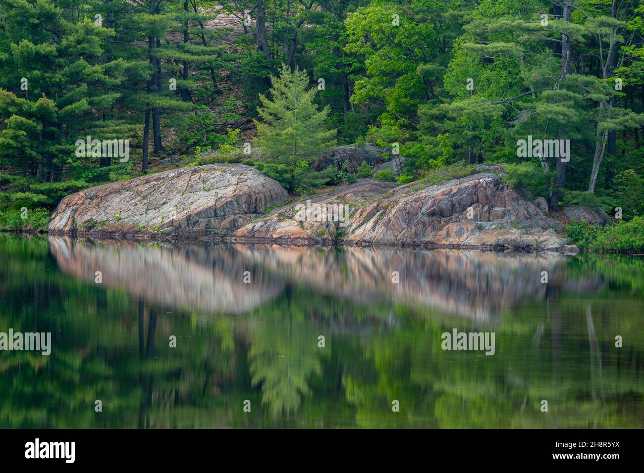 Granite outcrop reflections in George Lake, Killarney Provincial Park ...