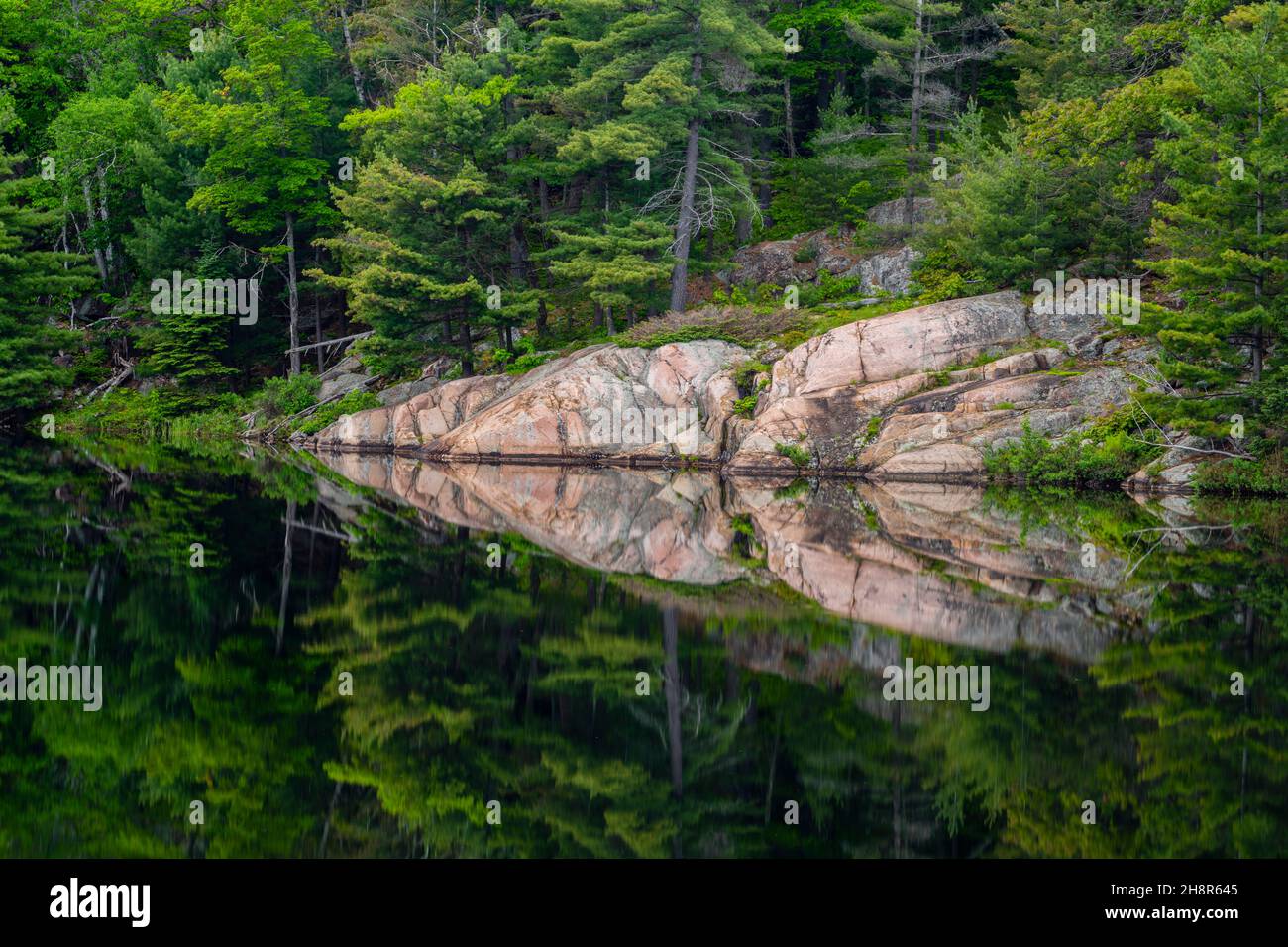 Granite outcrop reflections in George Lake, Killarney Provincial Park ...