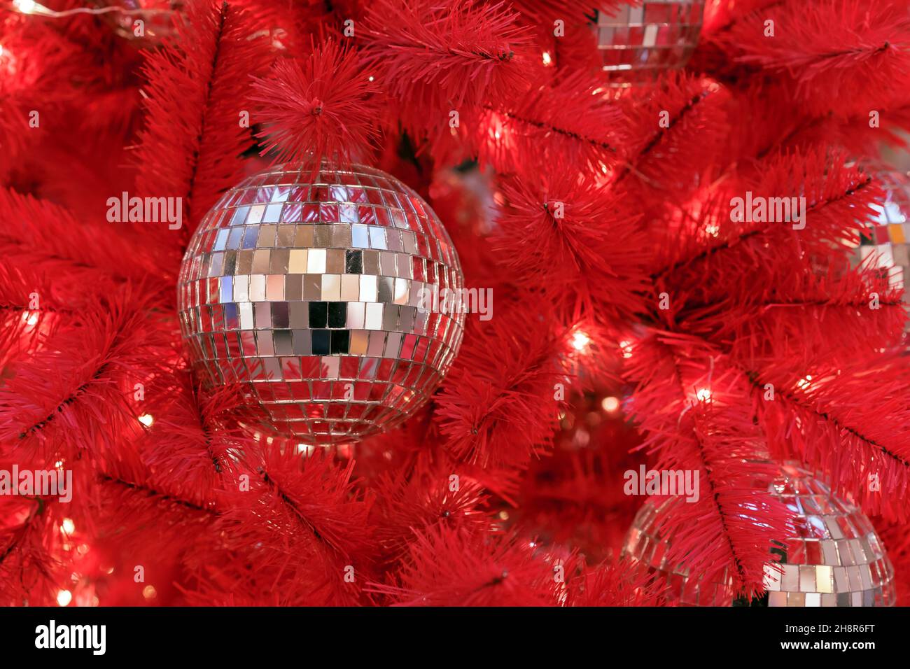 Christmas disco ball on a red Christmas tree Stock Photo - Alamy