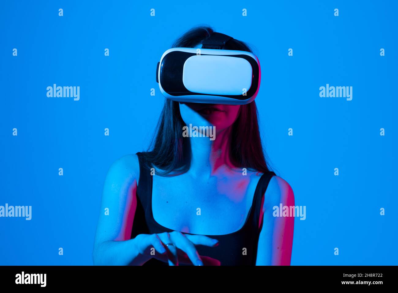 Female engineer wearing virtual reality headset designing a new ...