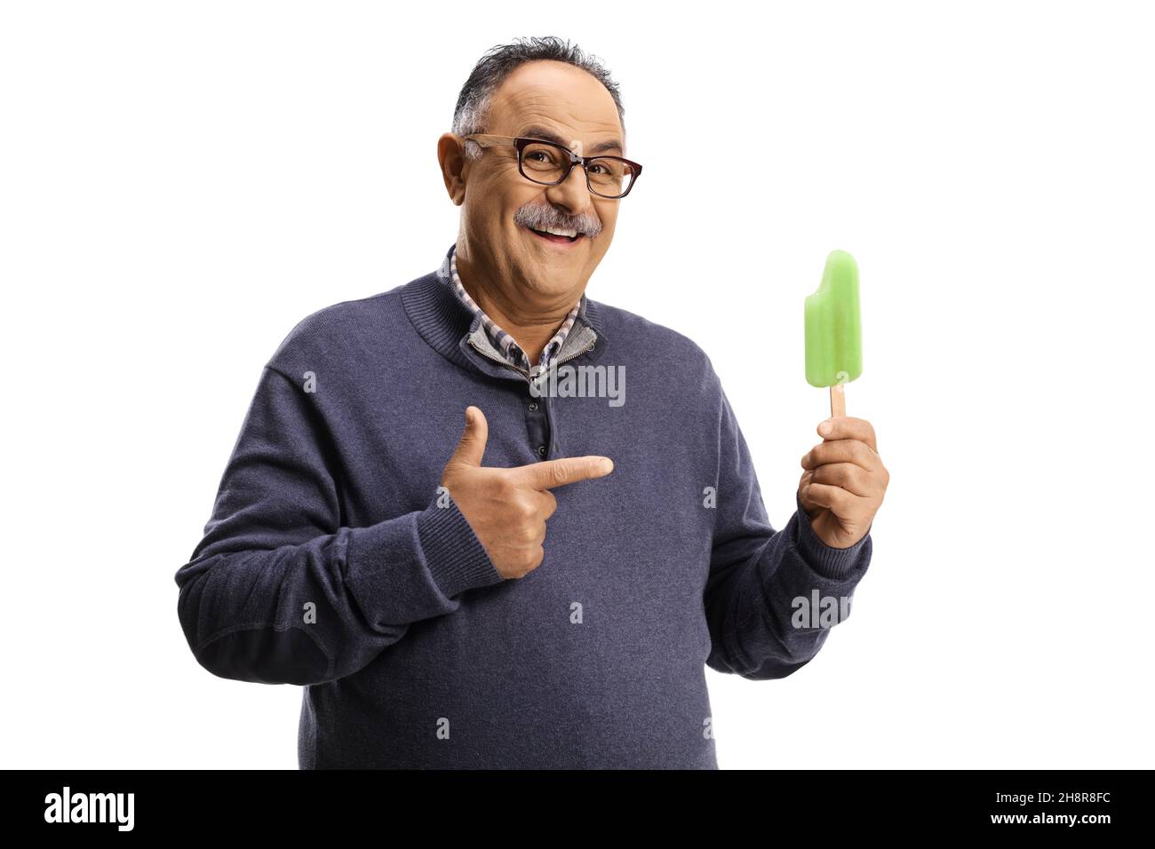 Happy mature man holding an ice pop and pointing isolated on white ...