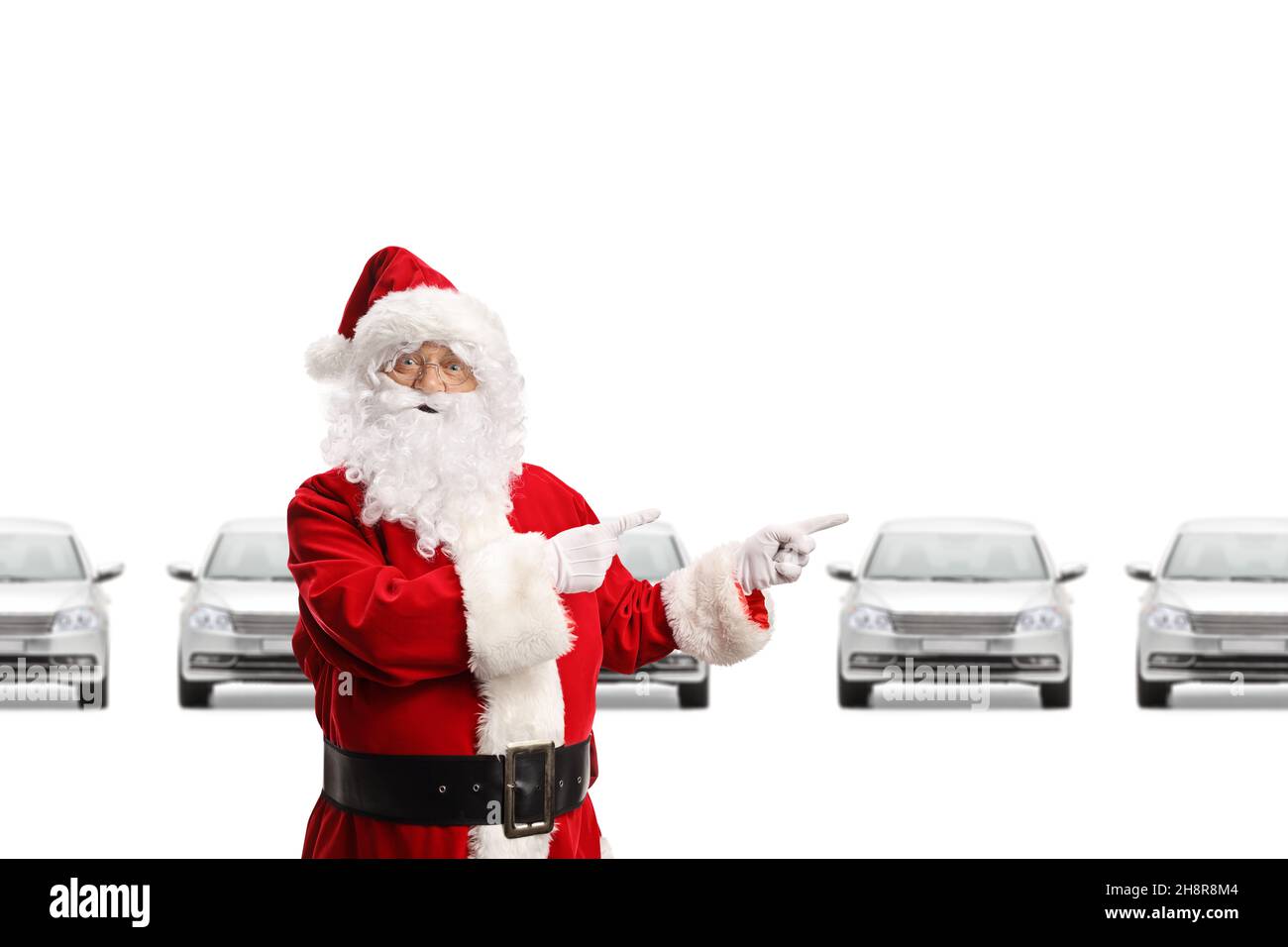 Santa Claus pointing at a row of silver cars isolated on white ...