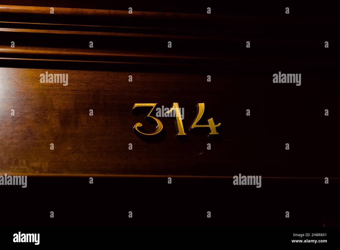 Number 314 in gilt on wooden door frame Stock Photo - Alamy