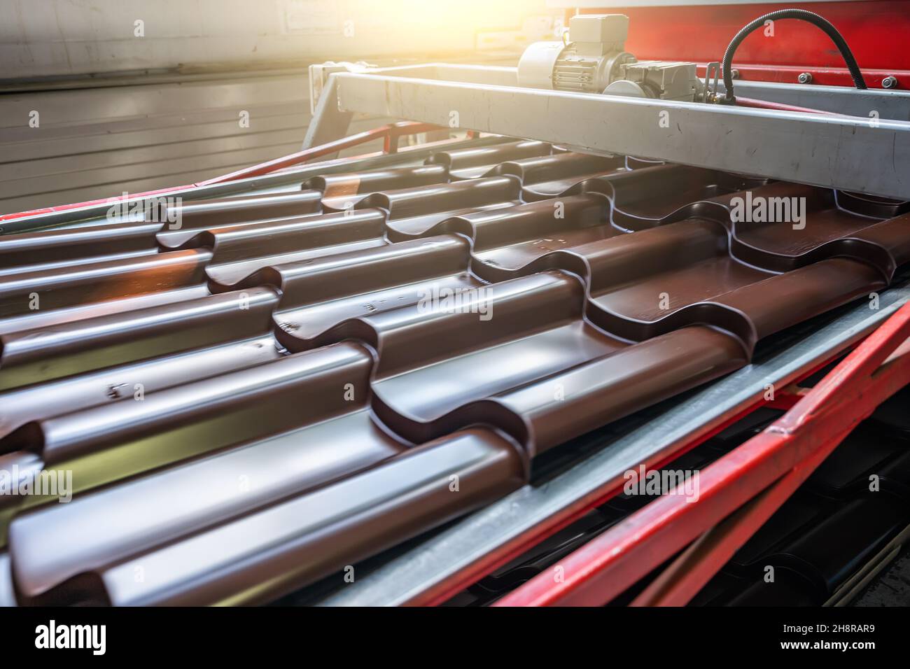 Metal tile for roof in metal forming machine production line close up ...