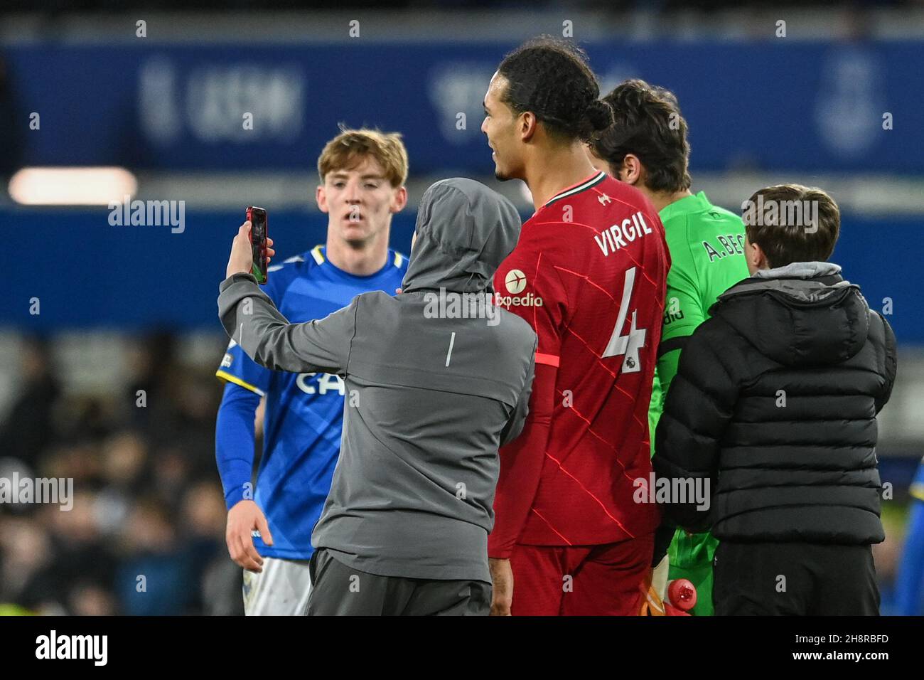 A young Liverpool fan invades the pitch for a selfie with Virgil van ...