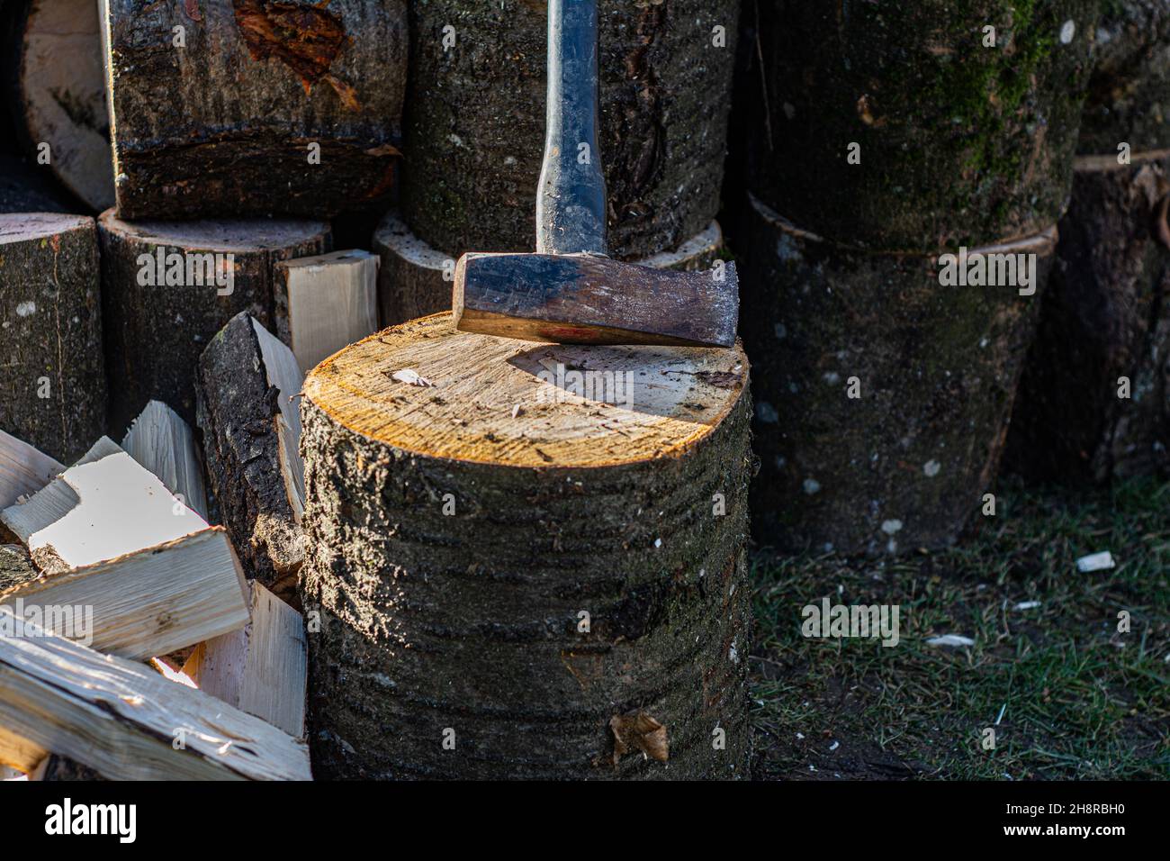 an ax in a hemp on logs background Stock Photo - Alamy