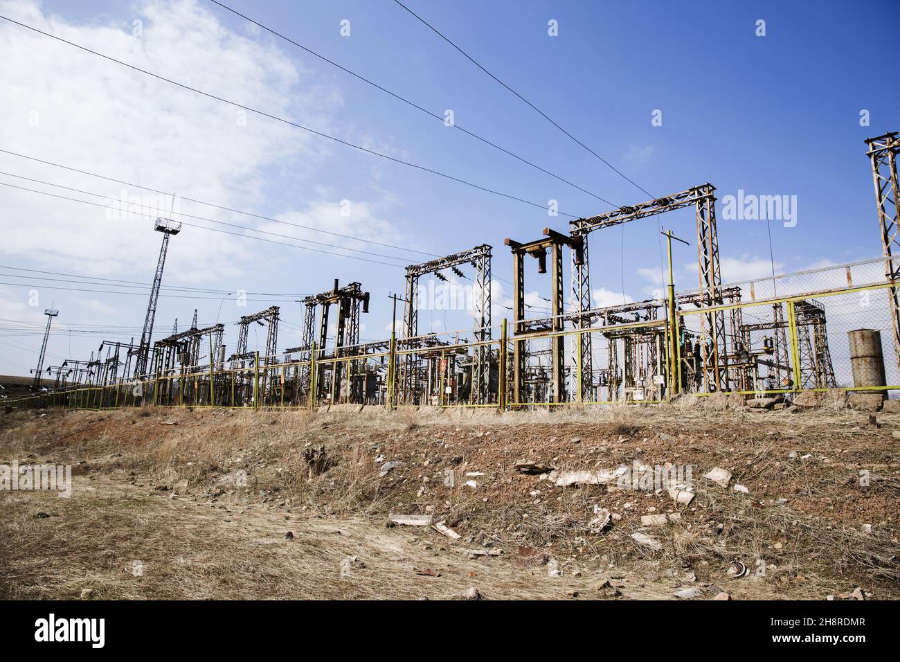 High voltage post with transmission towers Stock Photo - Alamy