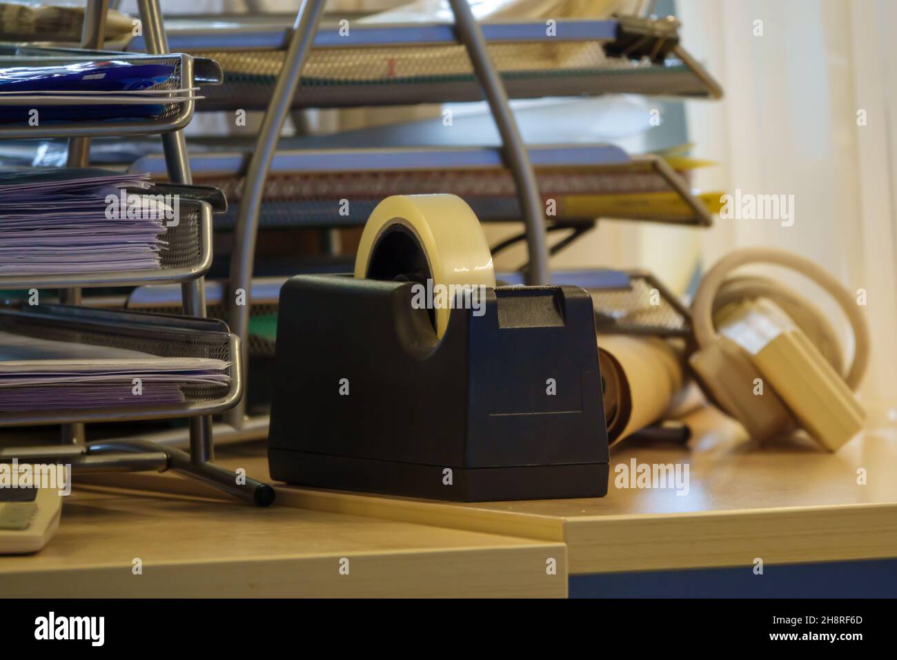 sticky tape dispenser with a full reel of sticky tape mounted, on a ...