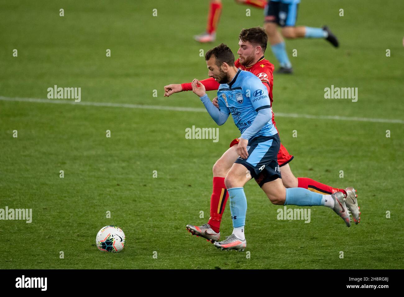 Sydney FC forward Adam Le Fondre (9) and Adelaide United player Ryan Strain (4) fight for the ...