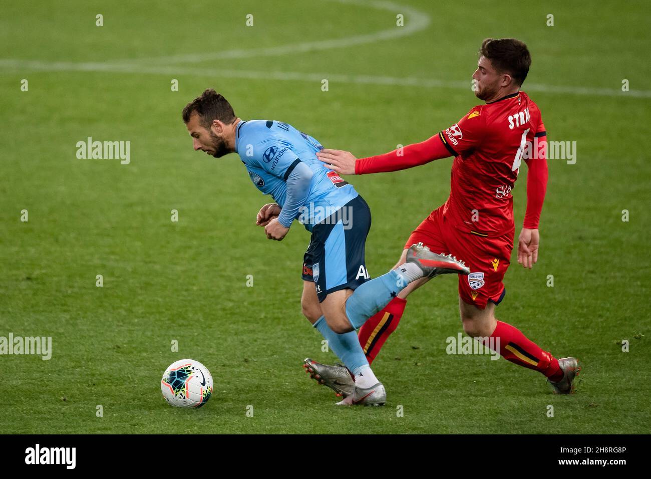 Sydney FC forward Adam Le Fondre (9) and Adelaide United player Ryan Strain (4) collide Stock ...