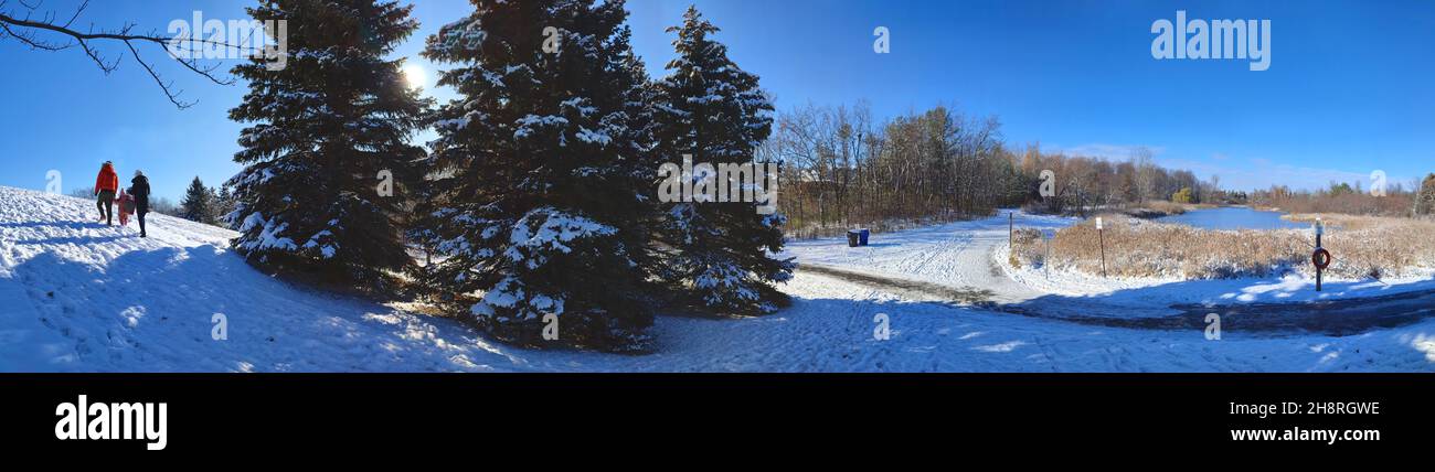 Panoramic view of the beautiful snow-covered slope in the public park ...