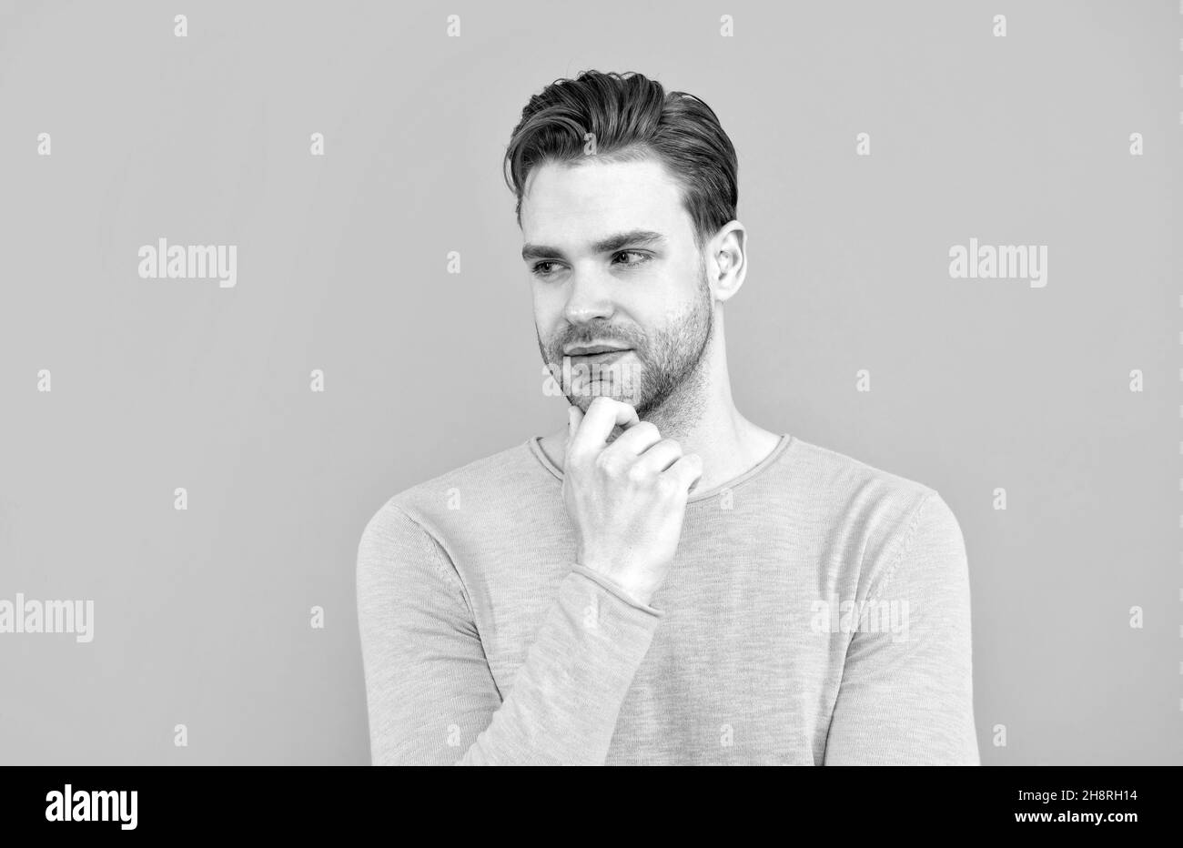 Handsome man with unshaven face portrait grey background, serious Stock ...