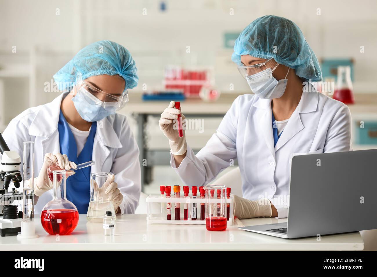 Scientists working with sample in laboratory Stock Photo - Alamy